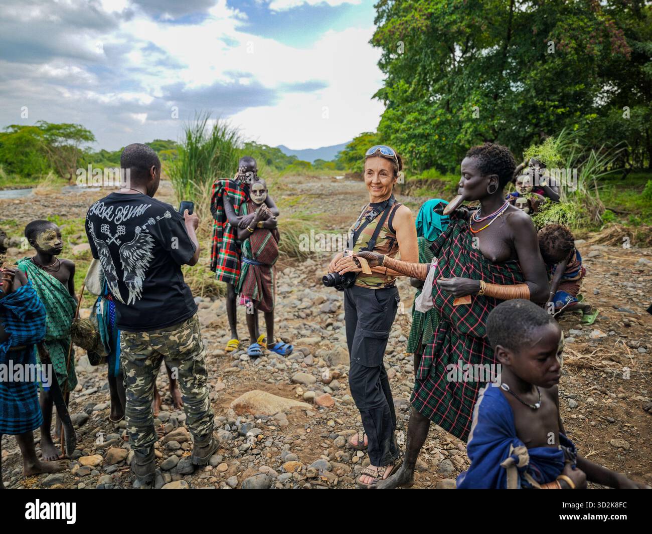 Kibish, Ethiopia - 12 August 2025: people of Suri tribe with a tourist ...