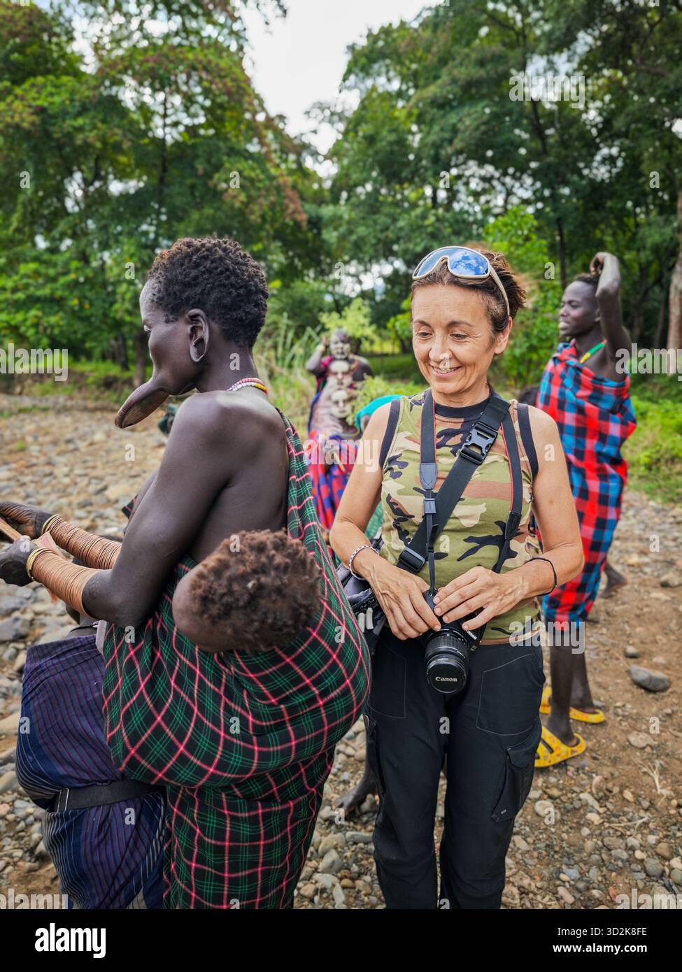 Kibish, Ethiopia - 12 August 2025: people of Suri tribe with a tourist ...