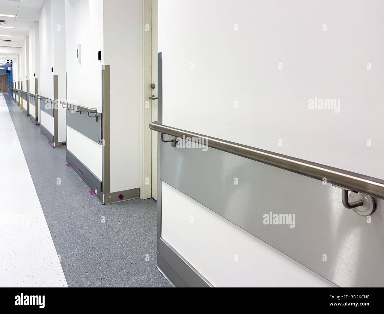 Brightly lit hospital corridor showcases modern architecture with ...