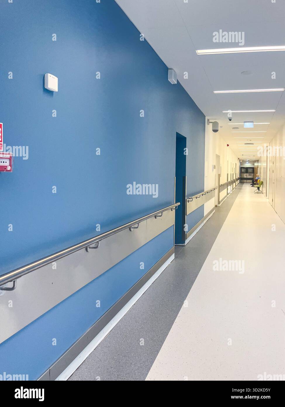 Brightly lit hospital corridor with modern design elements, featuring ...