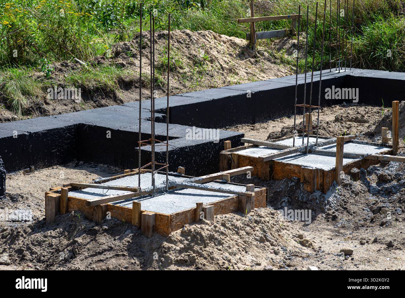 Wide foundation strips painted with black dispersion asphalt-rubber ...