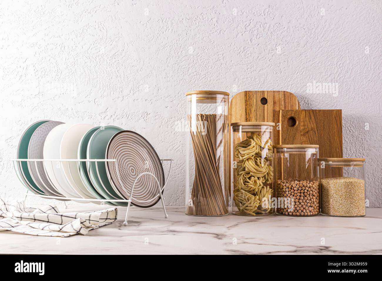 A set of eco-friendly kitchenware, plates in the dryer, glass jars with ...