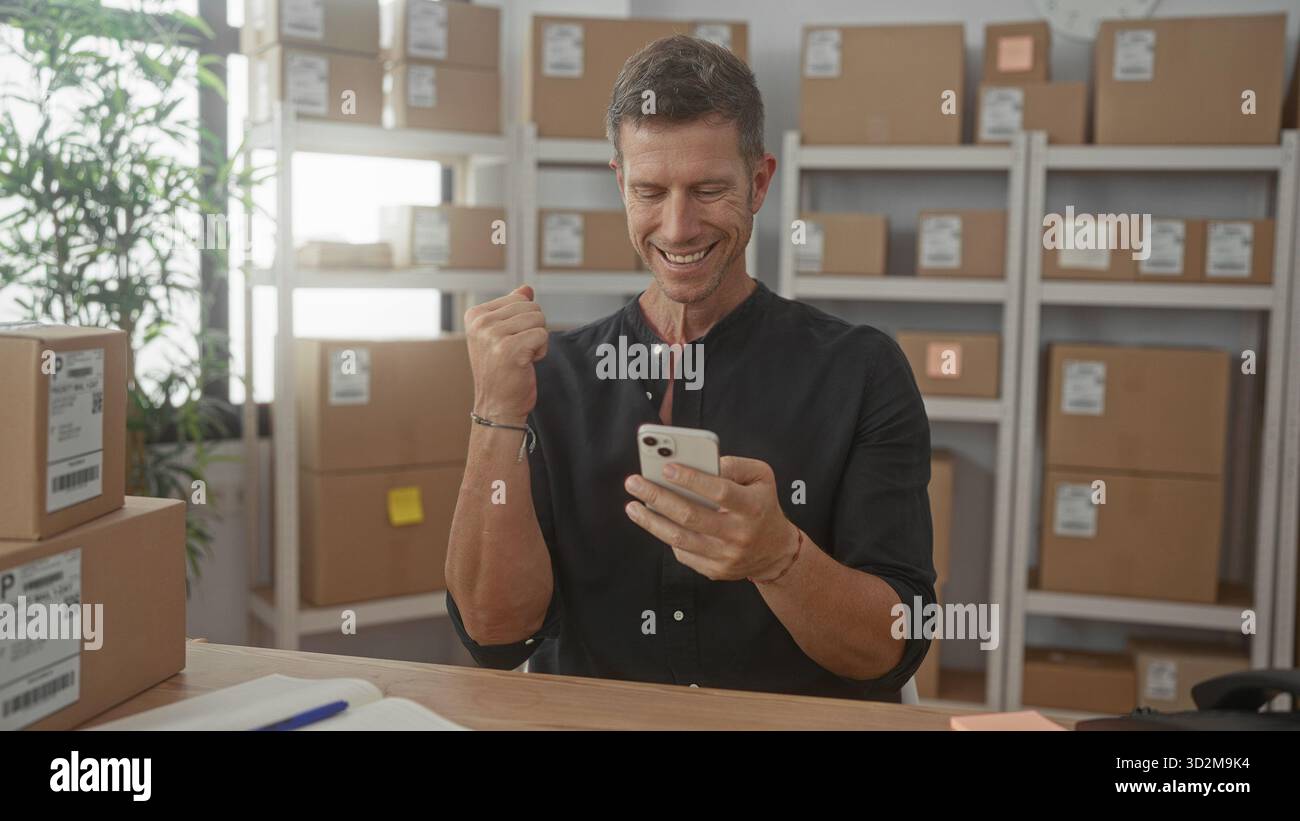 Man tapping smartphone and typing with thumb amid parcel shelves in ...