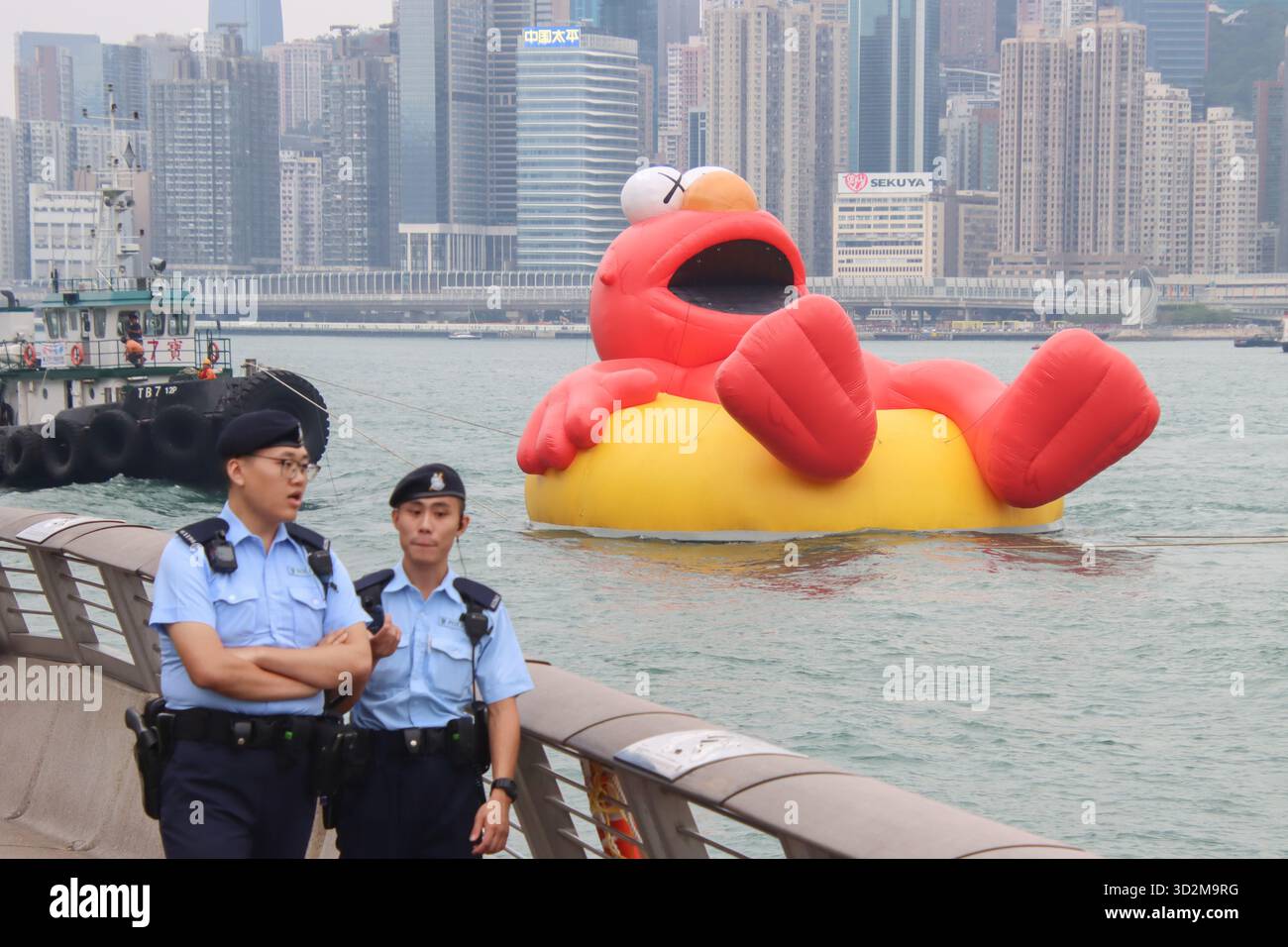 Police officer standing by at Avenue of Stars when floating inflatable ...