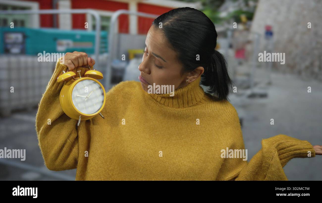 Woman shrugging yellow alarm hi-res stock photography and images - Alamy