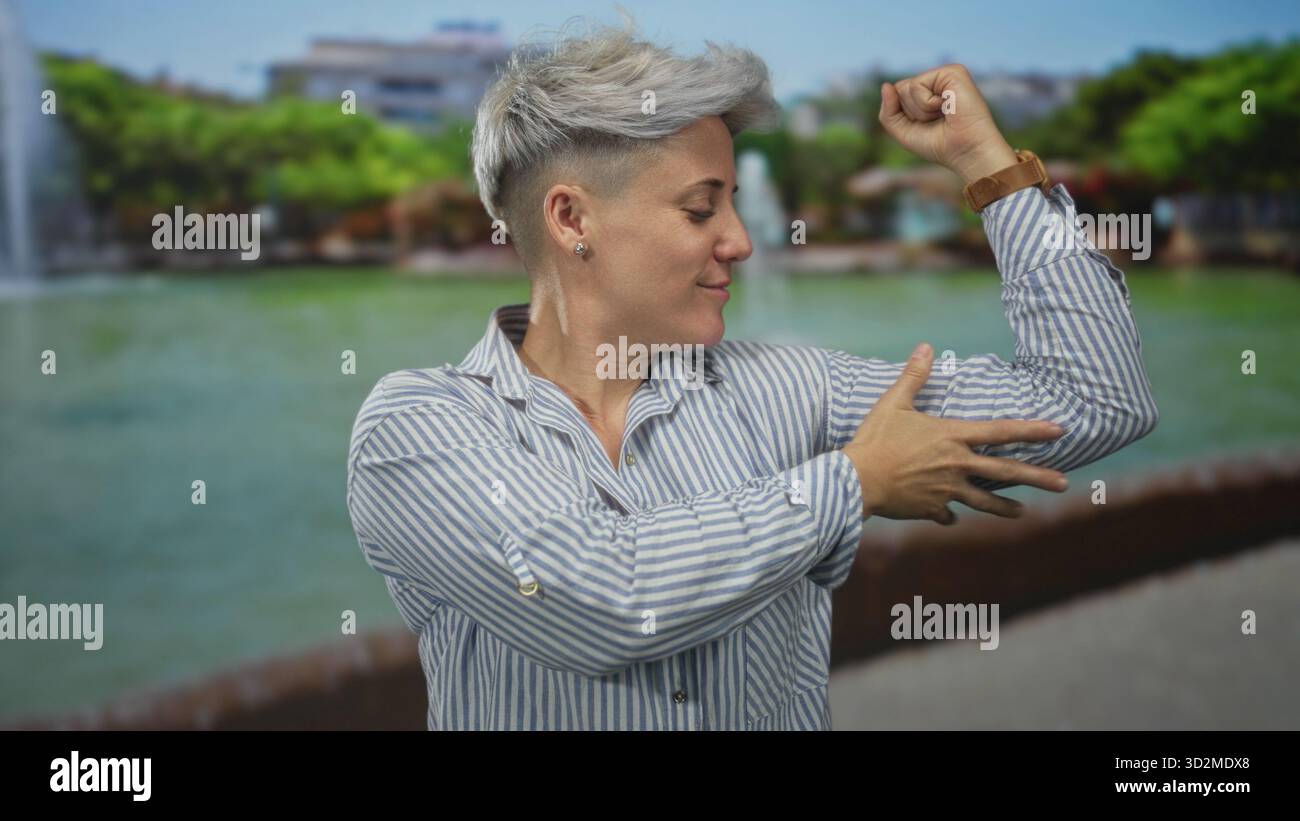 Woman flexes left arm hi-res stock photography and images - Alamy