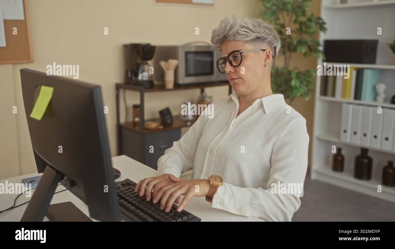 Woman hand holds paper document near computer monitor at desk in office ...