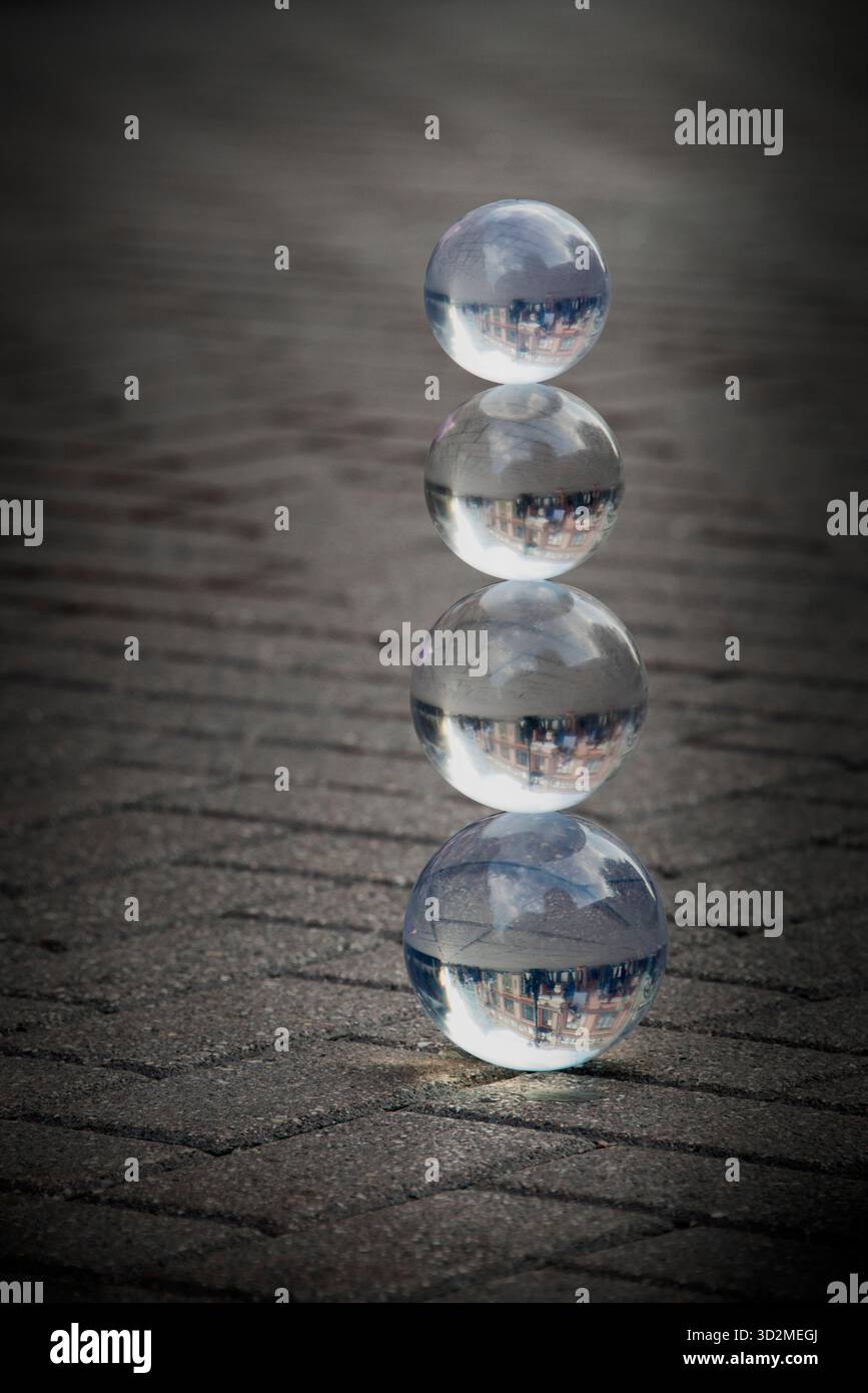 Four Stacked Crystal Balls Reflecting Cityscape on Paving Stones Stock ...