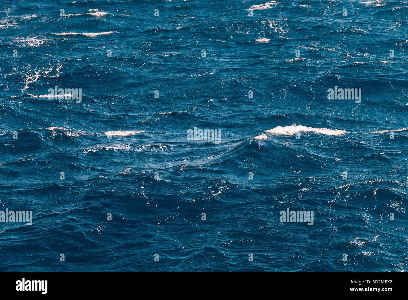 Vast ocean waves with deep blue water and white foam patterns Stock ...