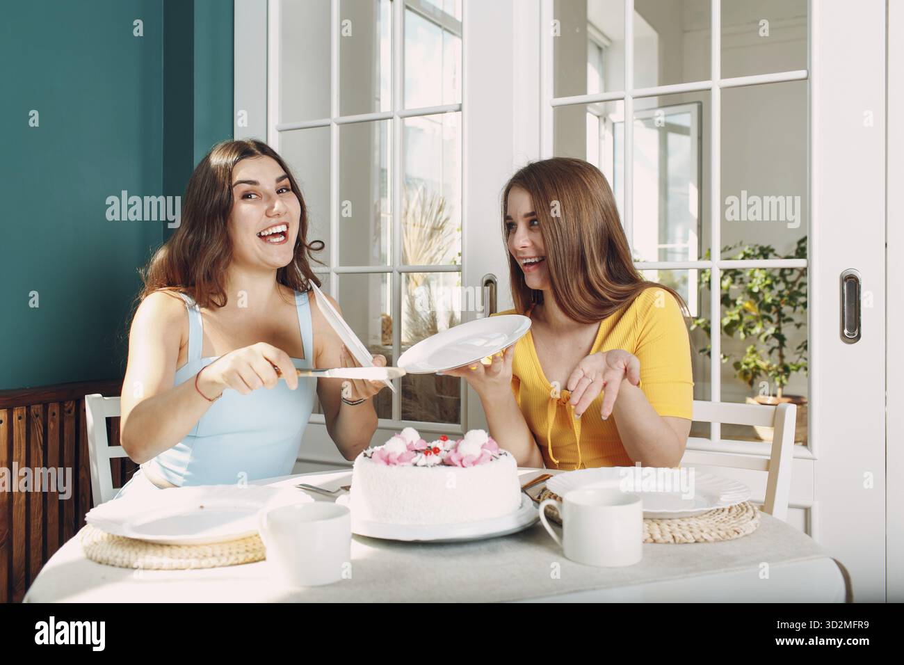 Women happy friends at home sitting and smiling with white birthday ...