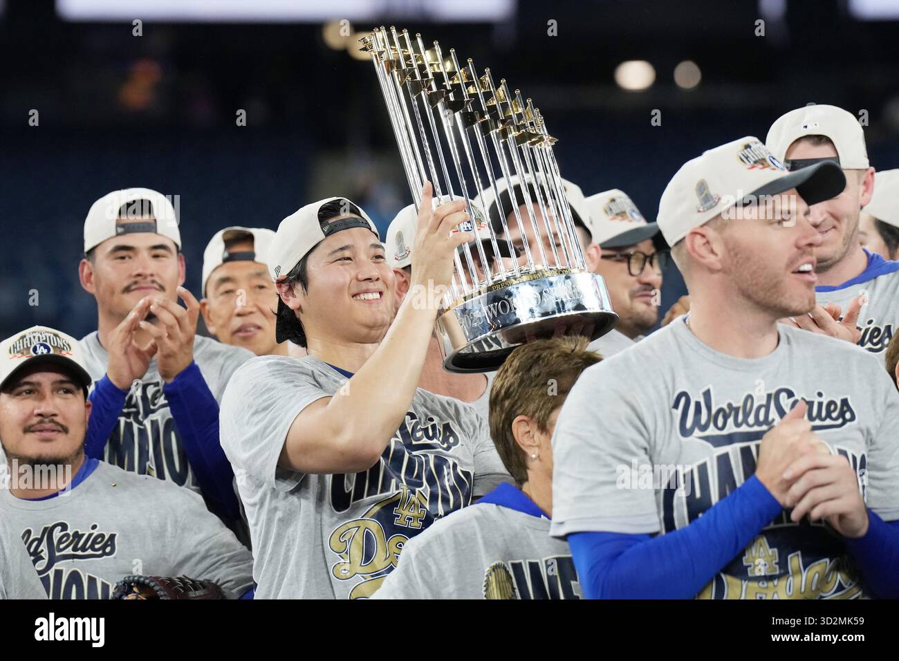 Los Angeles Dodgers' Shohei Ohtani (17) lifts the Commissioner's Trophy after the Dodgers ...
