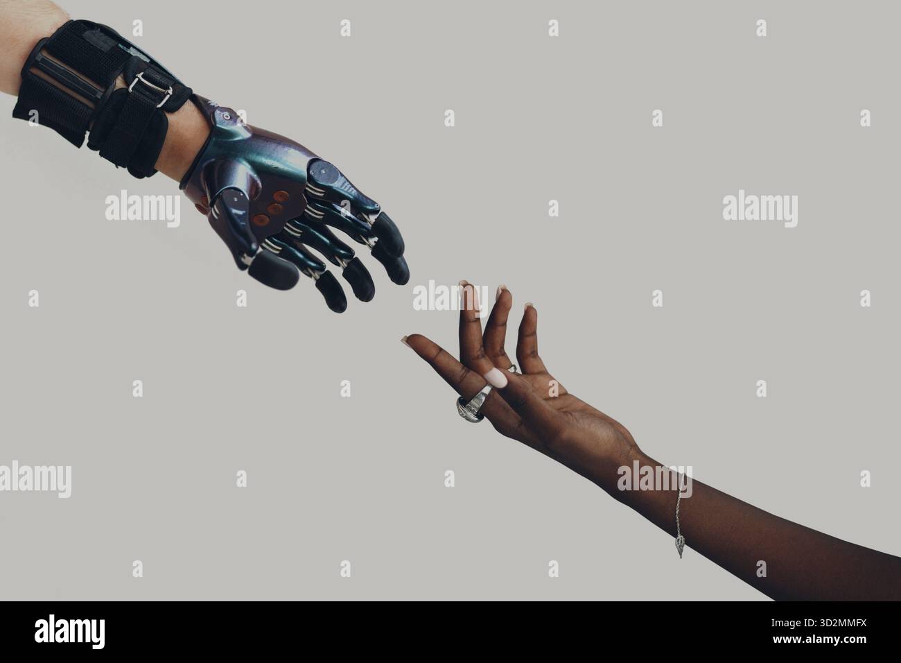 Male hand prosthesis cyborg reaching to female human black african hand ...