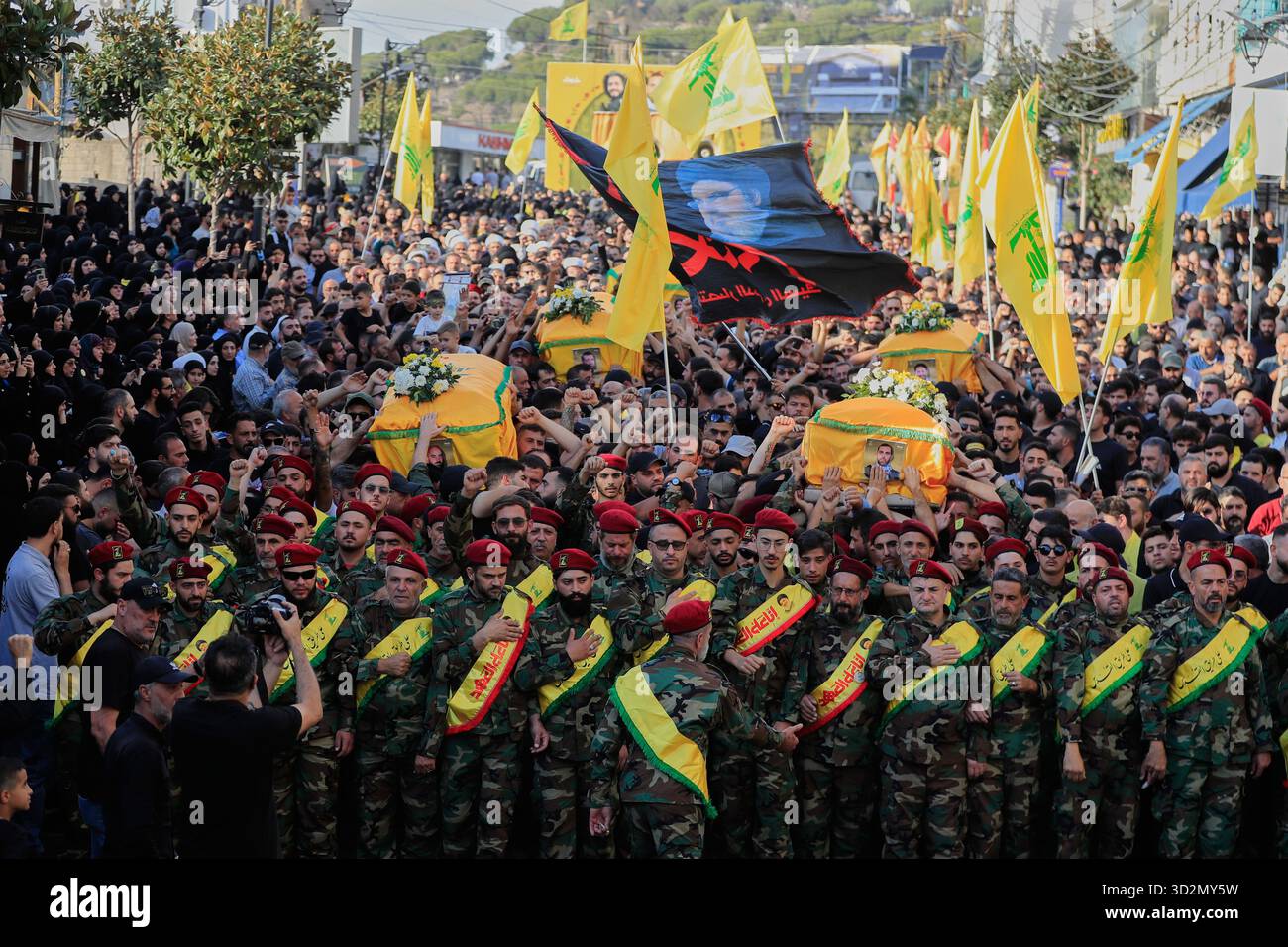 Mourners carry the coffins of five Hezbollah killed in Israeli strikes ...