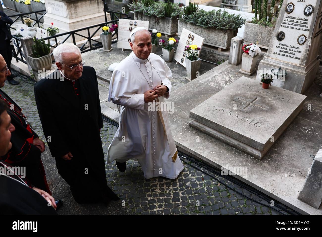 Pope Leo XIV walks away after laying a bouquet of white roses at a ...