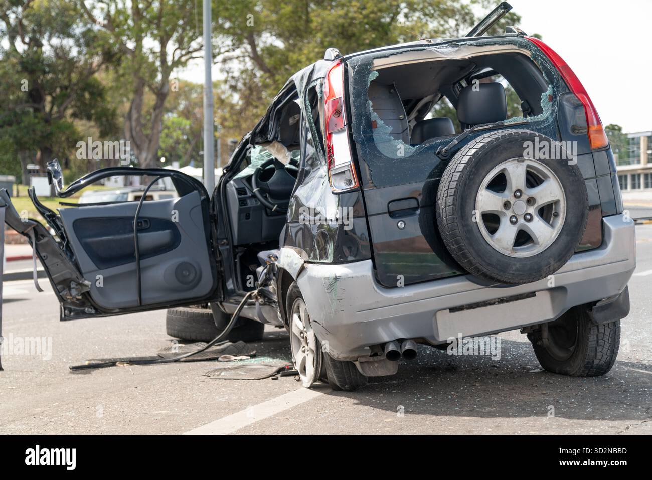 Suv vehicle showing heavy damage and broken glass on the asphalt after ...