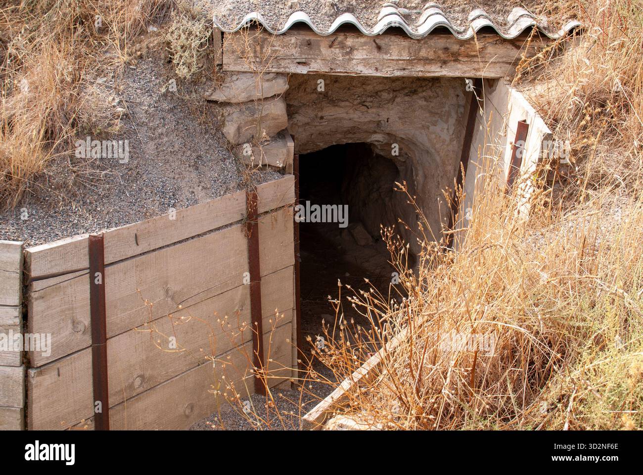 Entrance to a historical military trench, dugout into the dry earth ...