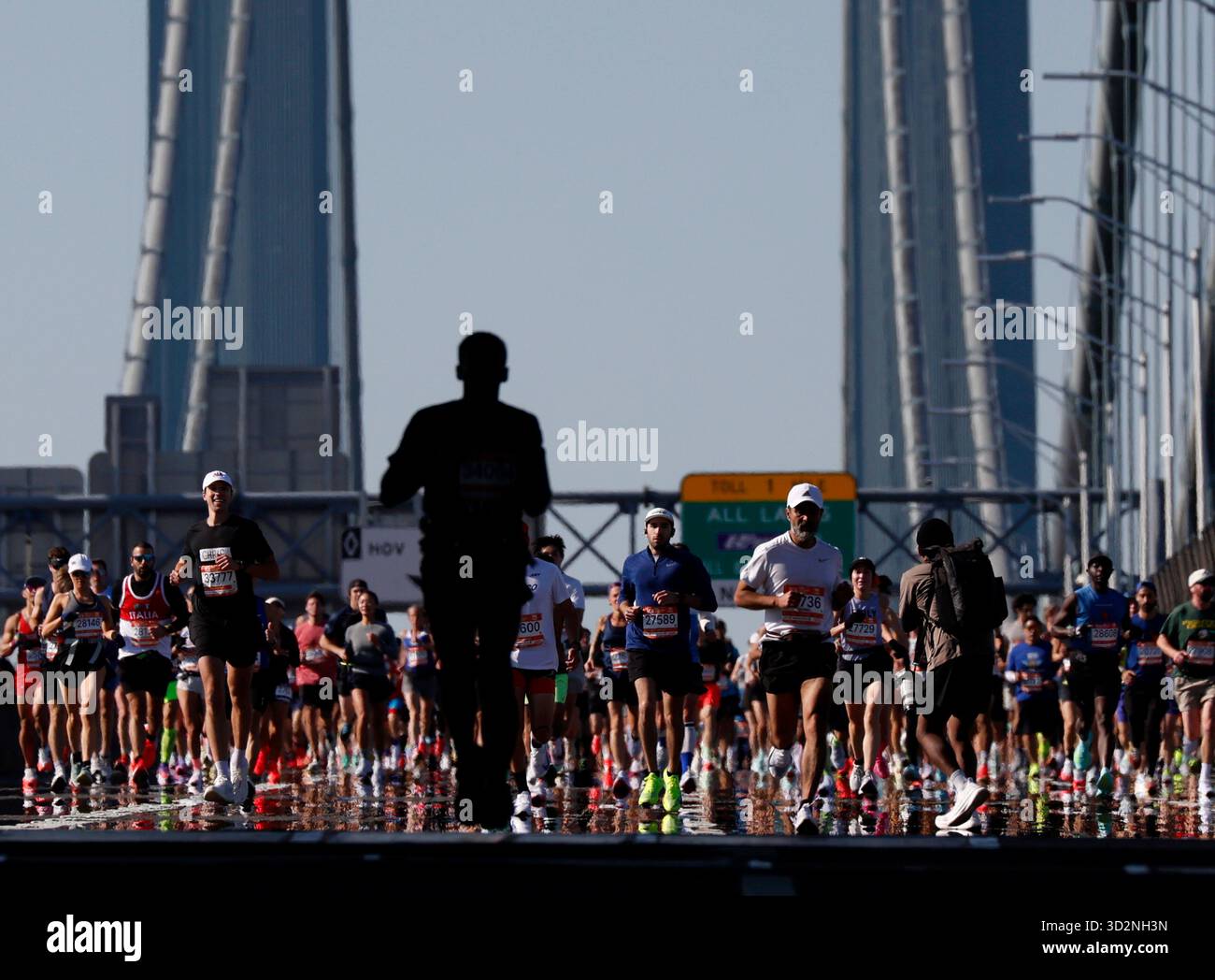 Runners cross over the span of Verrazzano-Narrows Bridge when they ...