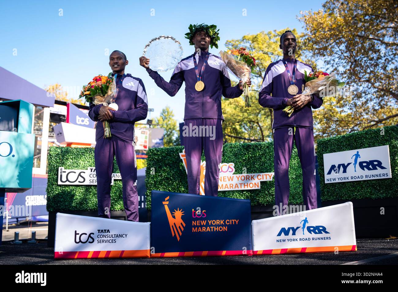 Alexander Mutiso, Benson Kipruto, and Albert Korir stand on the podium ...