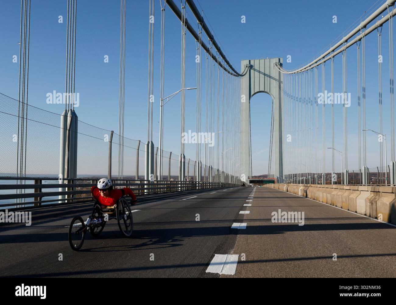 Competitors in the wheelchair division cross over the span of ...