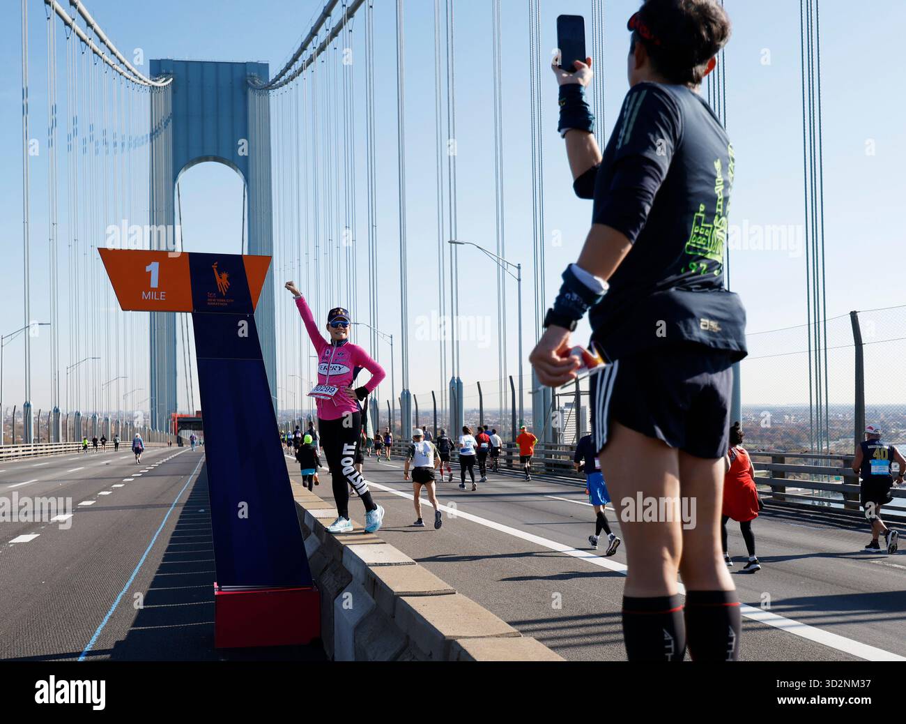 Runners stop for photos when they cross over the span of Verrazzano ...