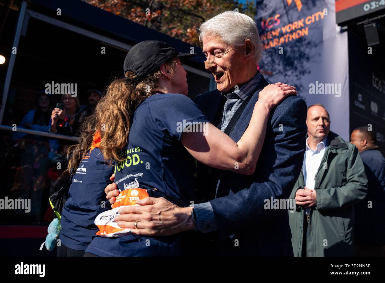 Former President Bill Clinton hugs his daughter, Chelsea Clinton, after ...