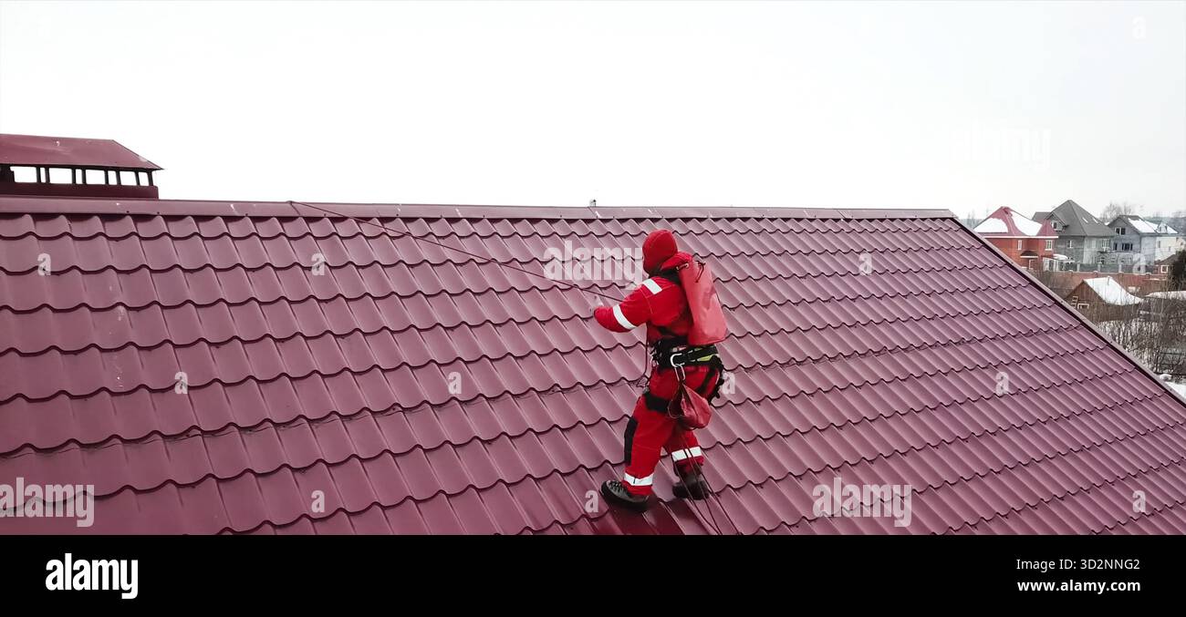 Worker does the installation of the roof of the house. Installation of ...