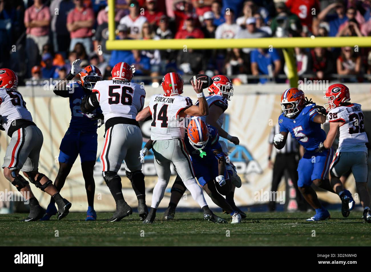 Georgia quarterback Gunner Stockton (14) is tackled by Florida safety Jordan Castell as he ...