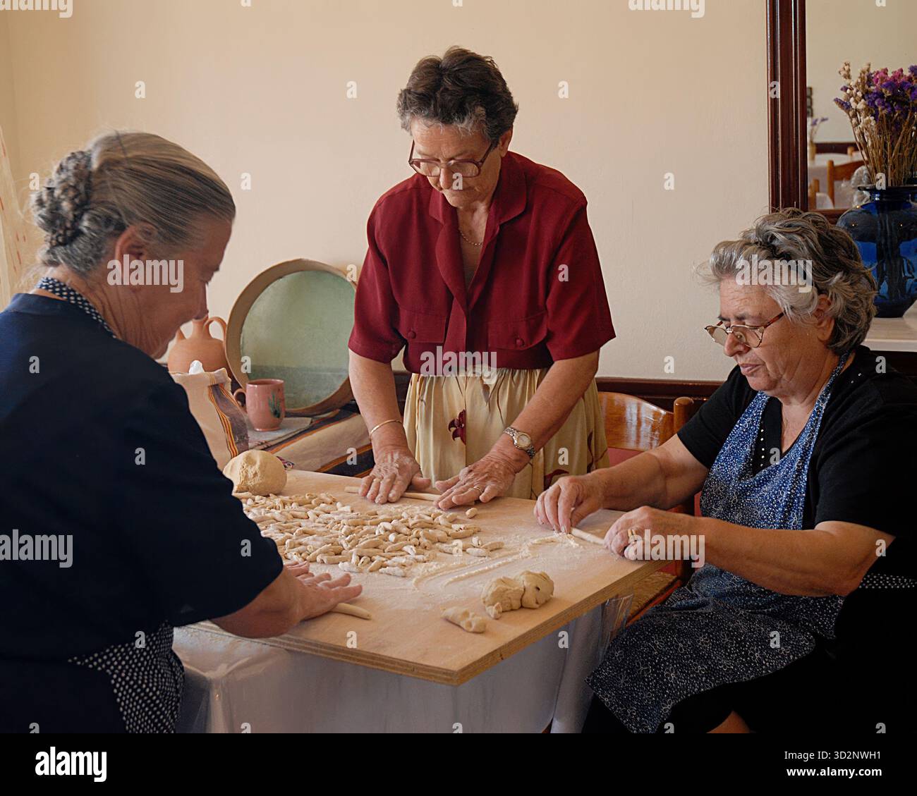 Generations of Tradition: Women Making Pasta in a Rustic Kitchen Stock ...