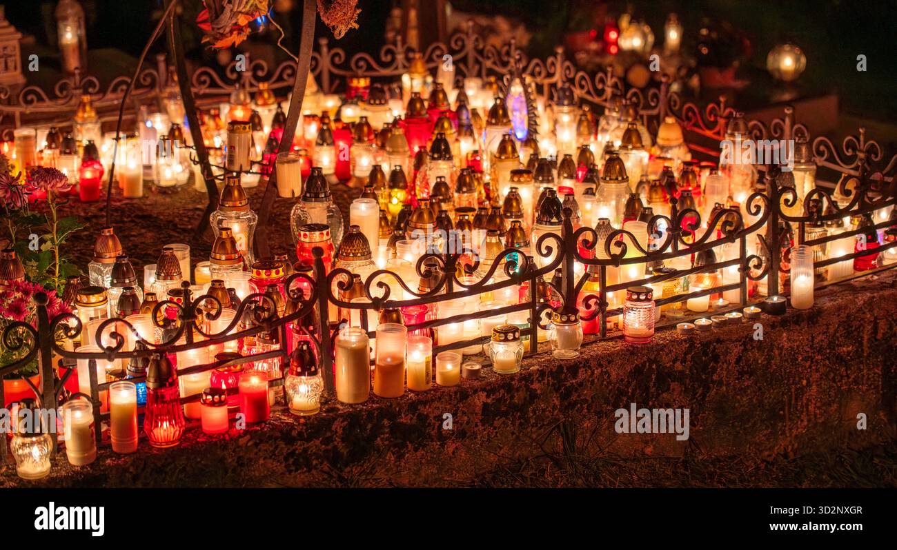Grave candles and lanterns at cemetery during the All Saints' Day ...
