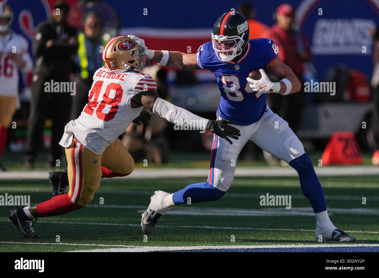 New York Giants tight end Theo Johnson (84) stiff arms San Francisco 49ers linebacker Tatum ...