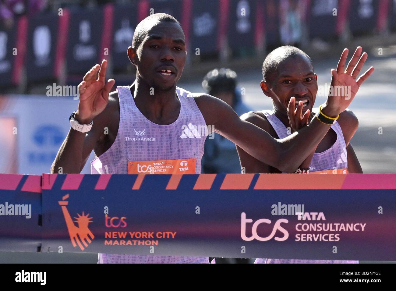 (L-R) Benson Kipruto and Alexander Mutiso of Kenya cross the finish ...