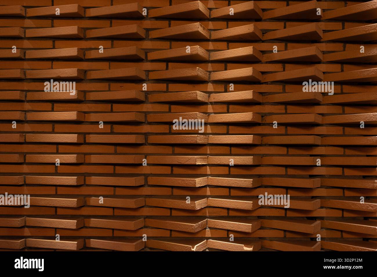 A modern brick wall with a dynamic, protruding pattern creates an ...