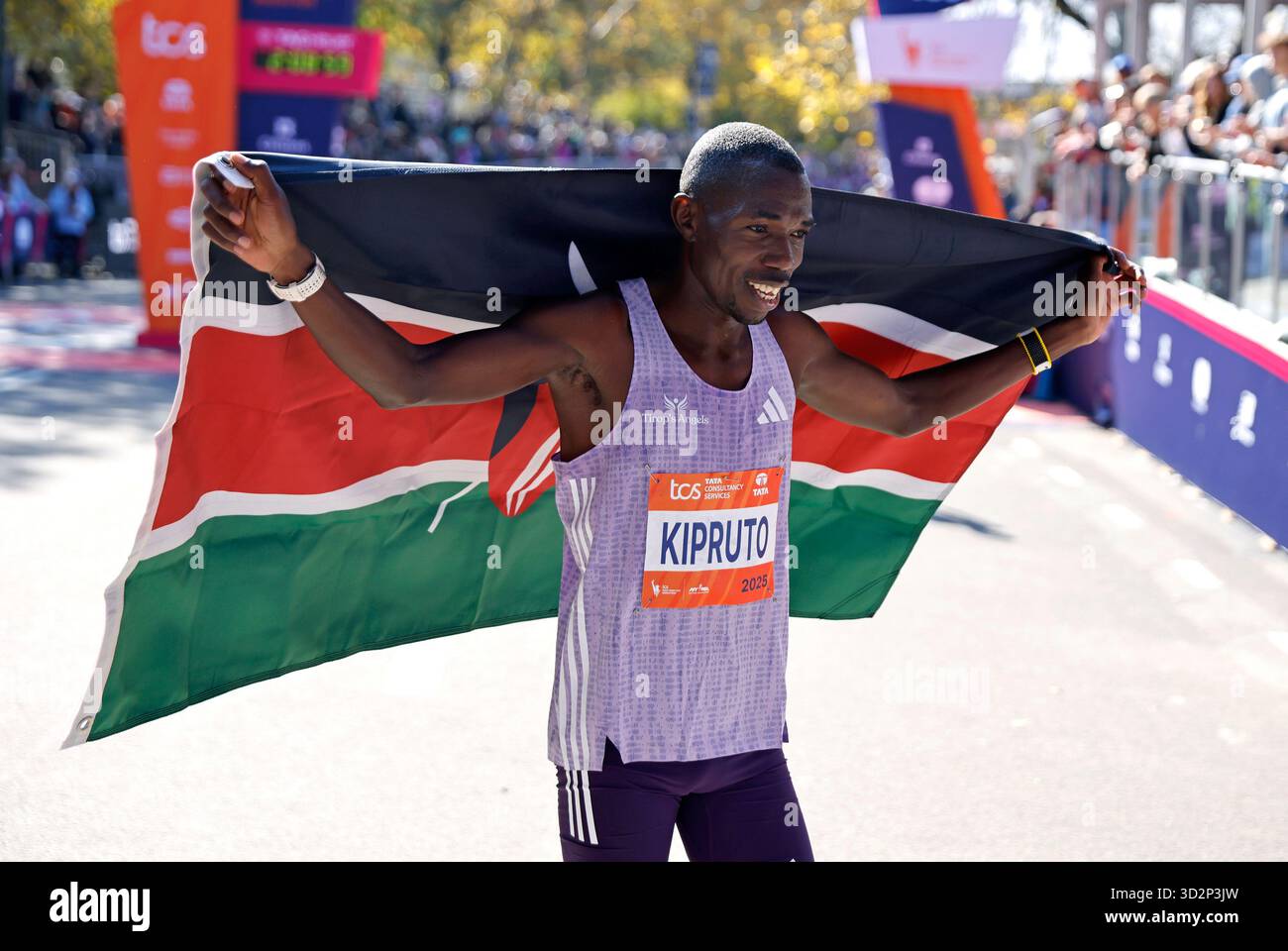 Benson Kipruto of Keyna, displays the Kenyan flag after winning the Pro ...