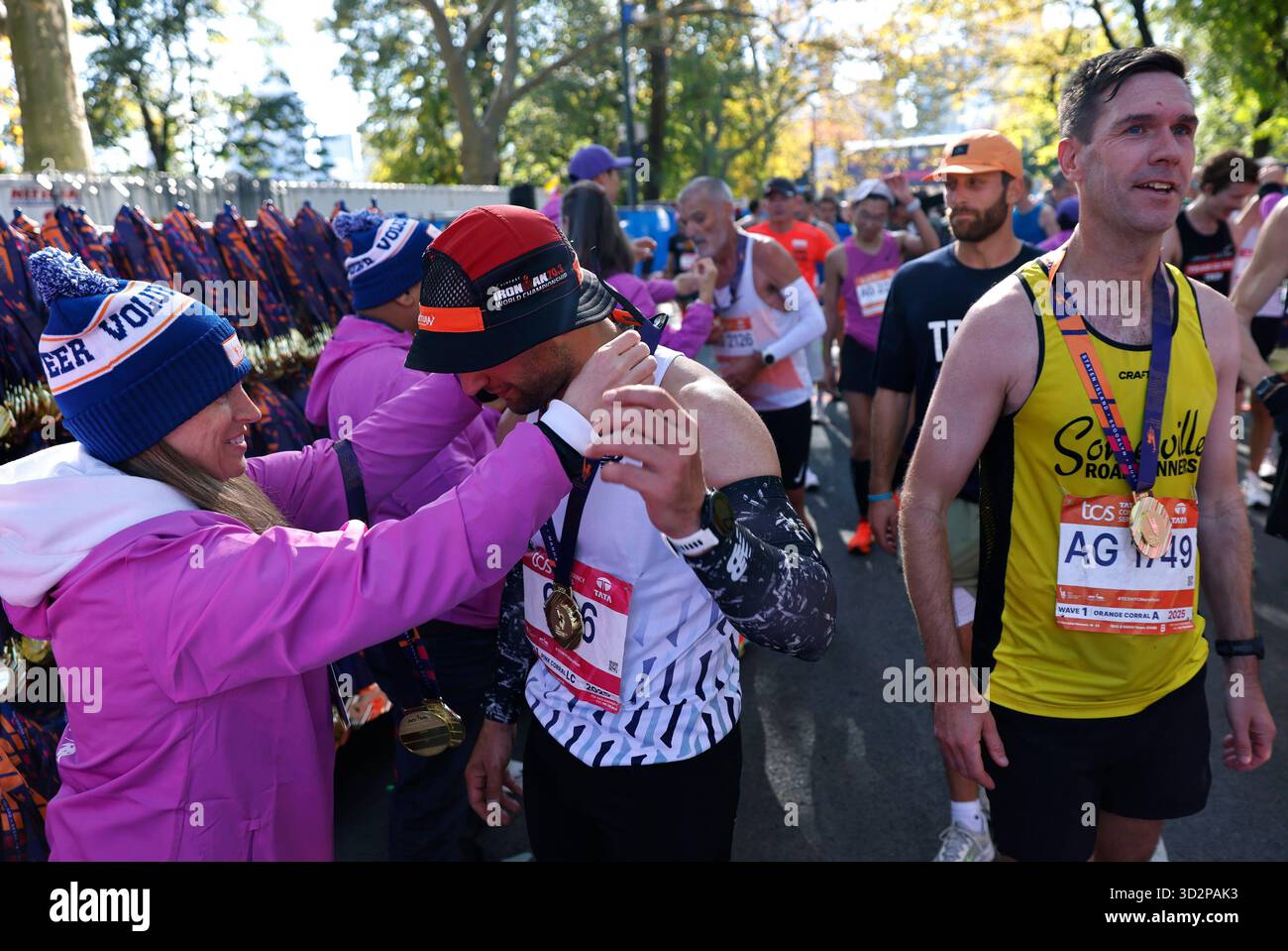Runners get their medals after finishing the 2025 NYRR TCS New York ...