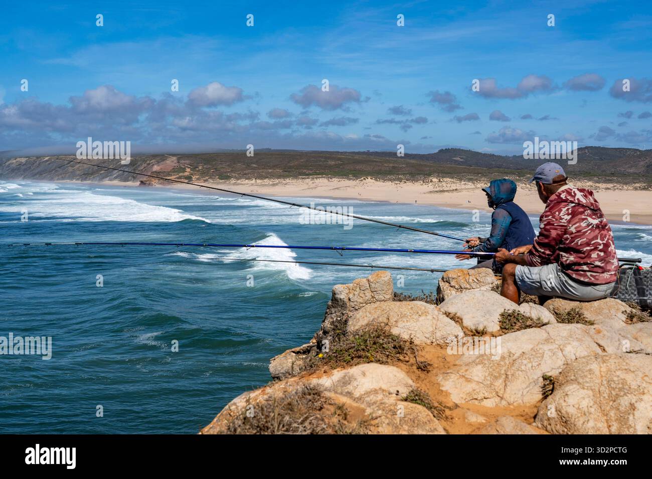 Anglers on the cliffs at the viewpoint above Praia da Bordeira beach ...