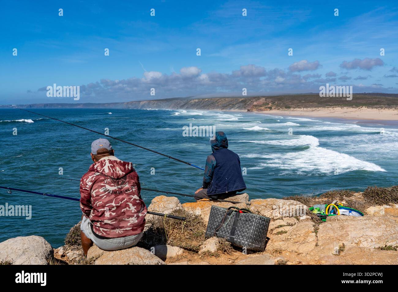 Anglers on the cliffs at the viewpoint above Praia da Bordeira beach ...