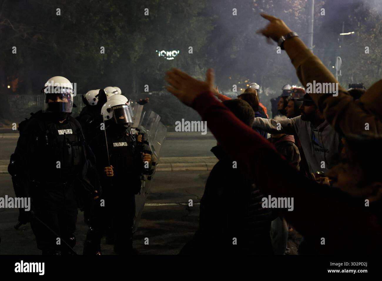 Serbian riot police separate rival crowds of opponents, right, and ...