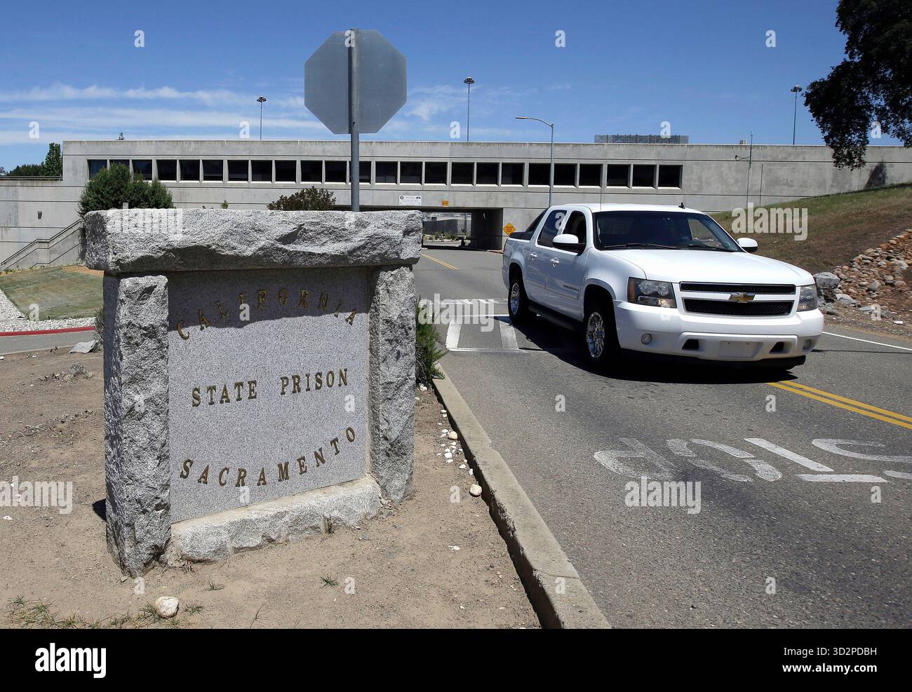 FILE - A vehicle drives by the main entrance to California State Prison ...