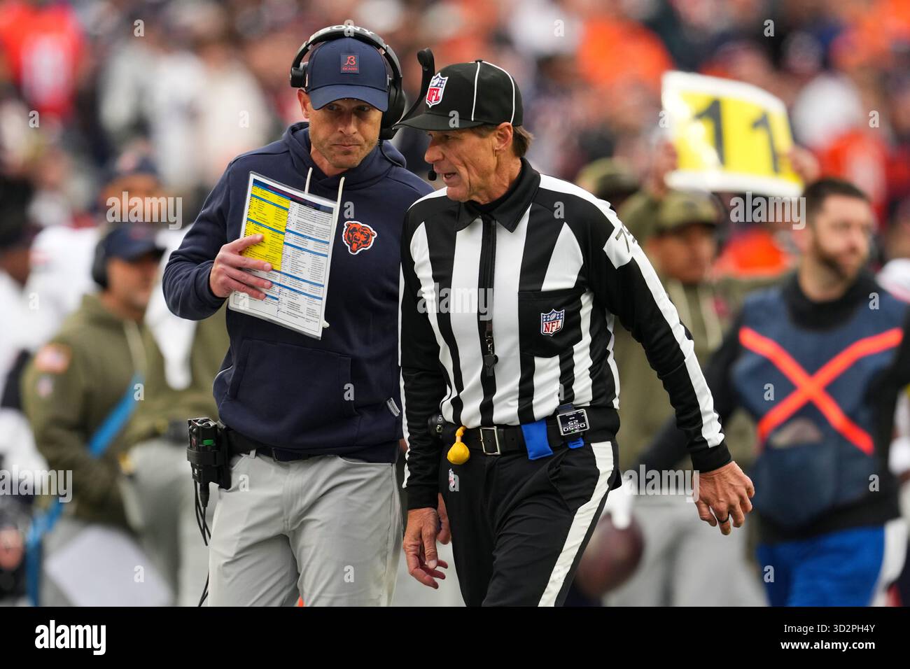 Chicago Bears head coach Ben Johnson, left, talks to an official during ...