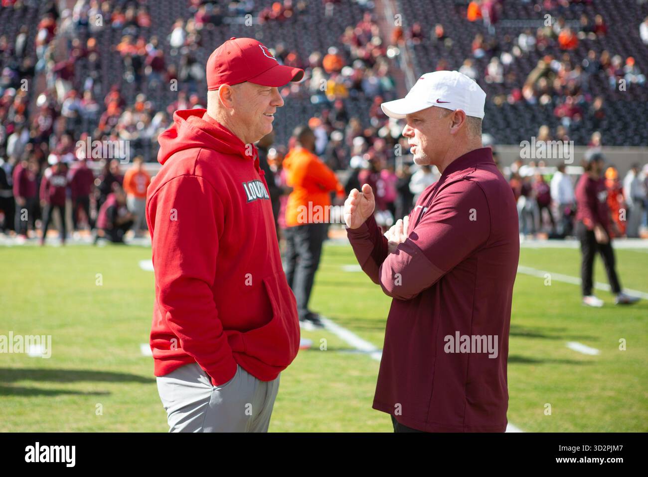 November 1, 2025: Louisville Cardinals head coach Jeff Brohm talks with ...