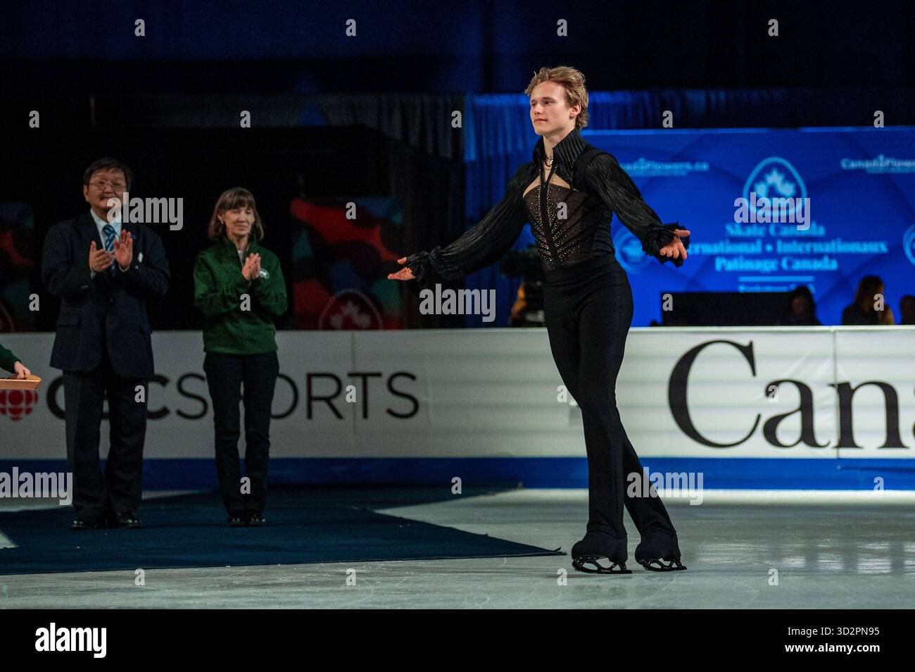 Ilia Malinin, right, of the United States, wins the gold medal in the ...