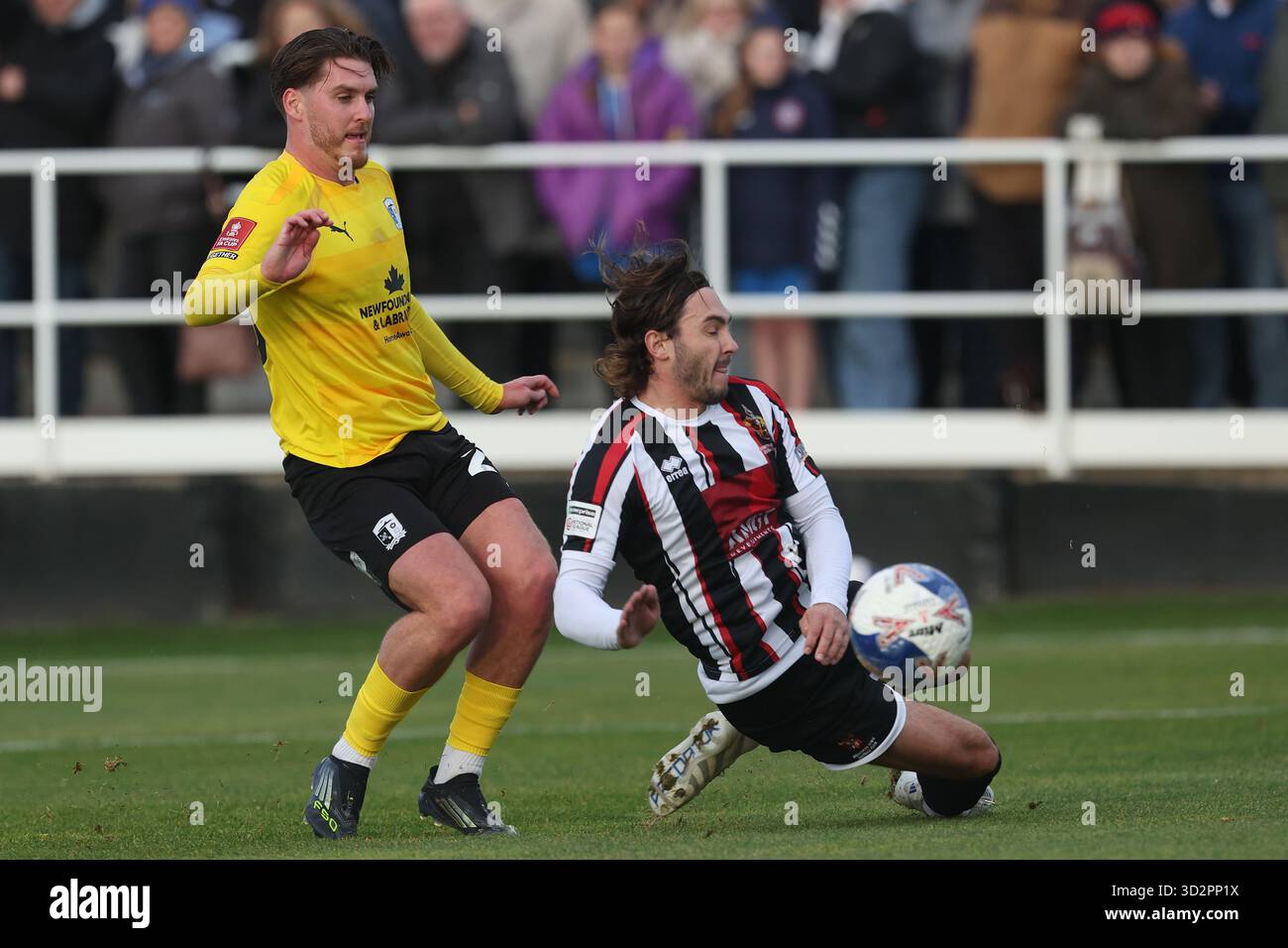 Connor Mahoney of Barrow gets a shot in despite the close attention of ...
