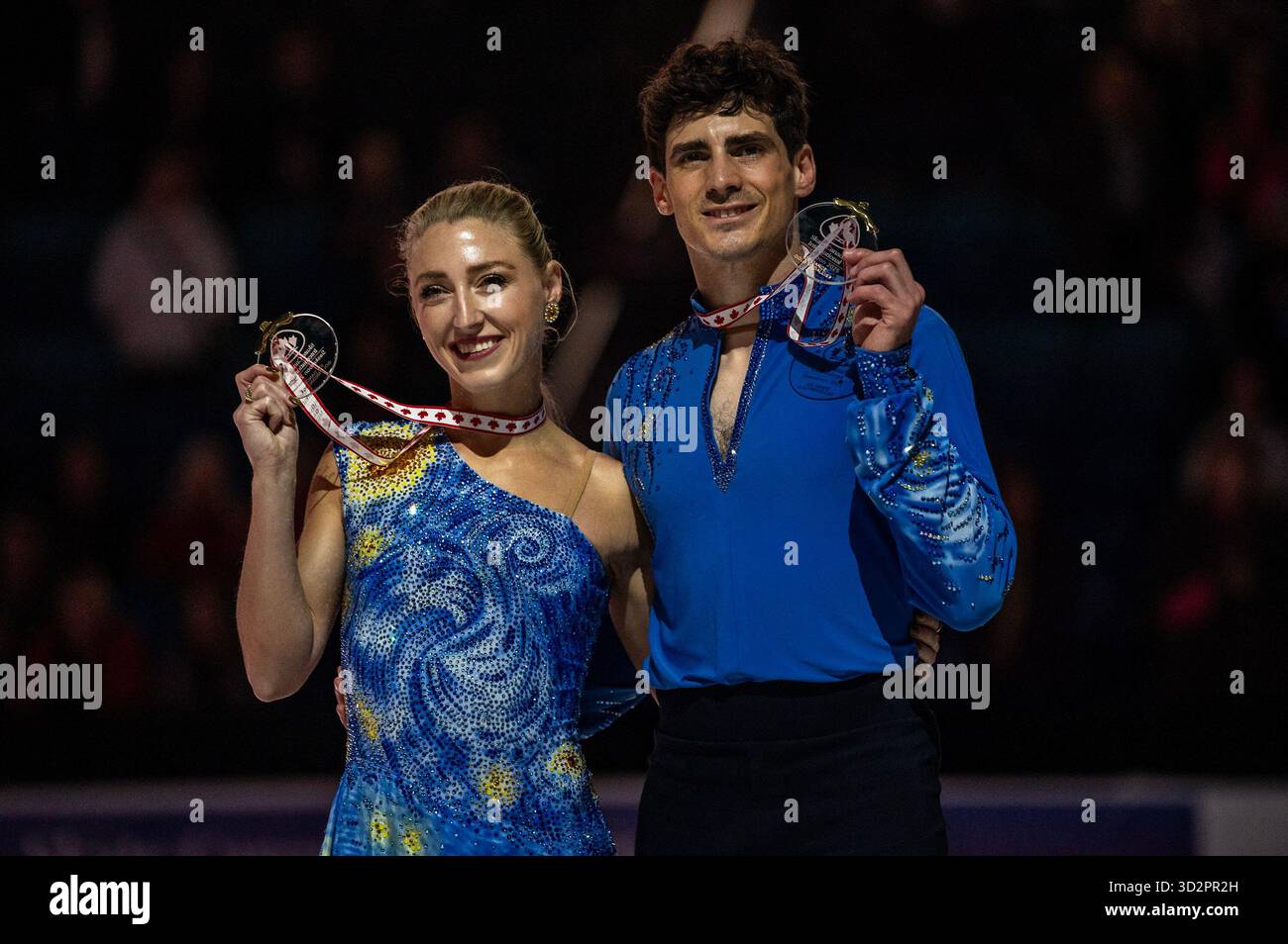 Piper Gilles and Paul Poirier, of Canada, display their gold medals ...