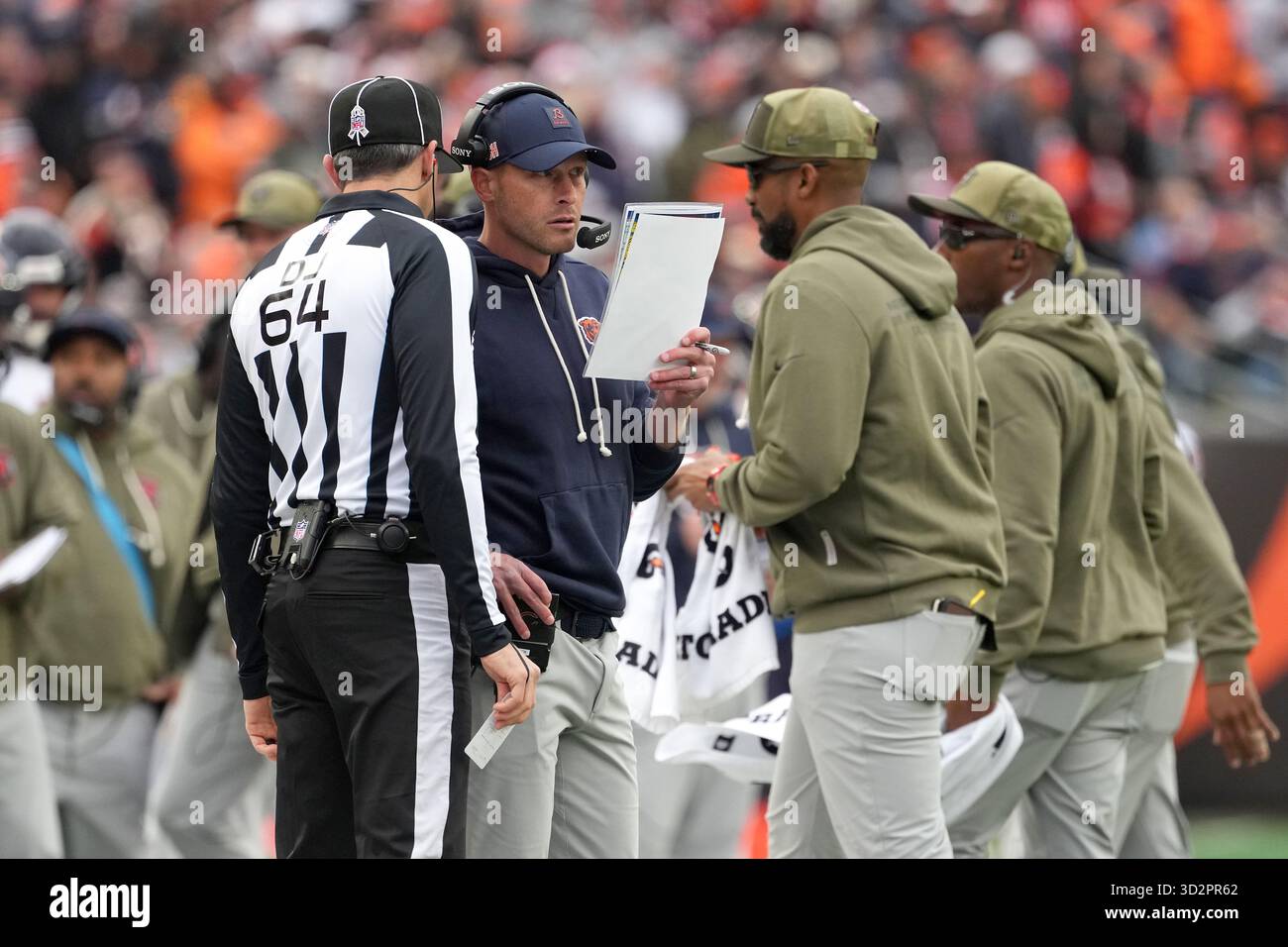 Chicago Bears head coach Ben Johnson talks with an official during an ...