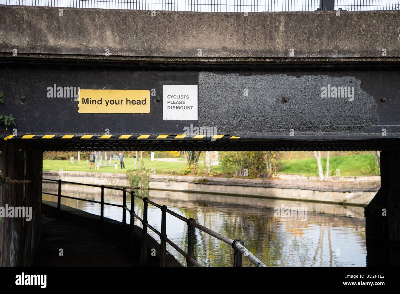 Two safety signs on a low bridge over the River Lea Navigation near ...