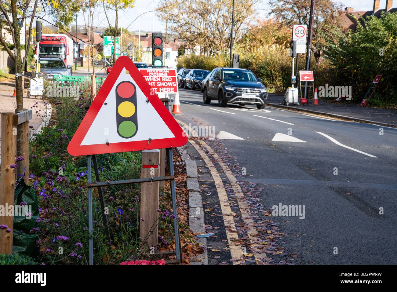 Triangle warning sign alerting drivers to upcoming traffic lights ...