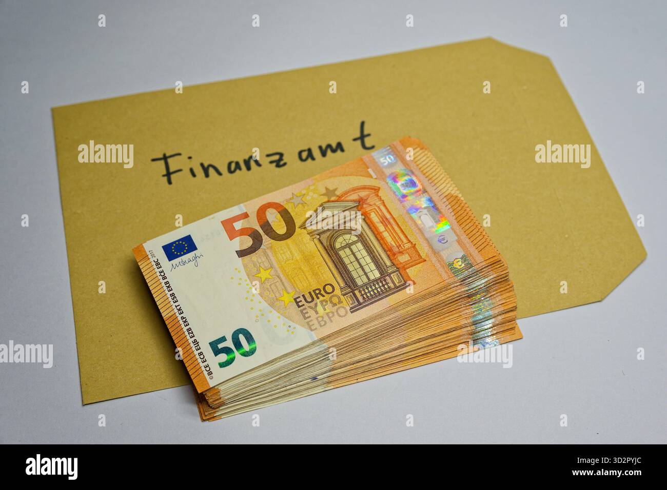 Concept image showing a stack of 50 euro bills placed on a brown ...