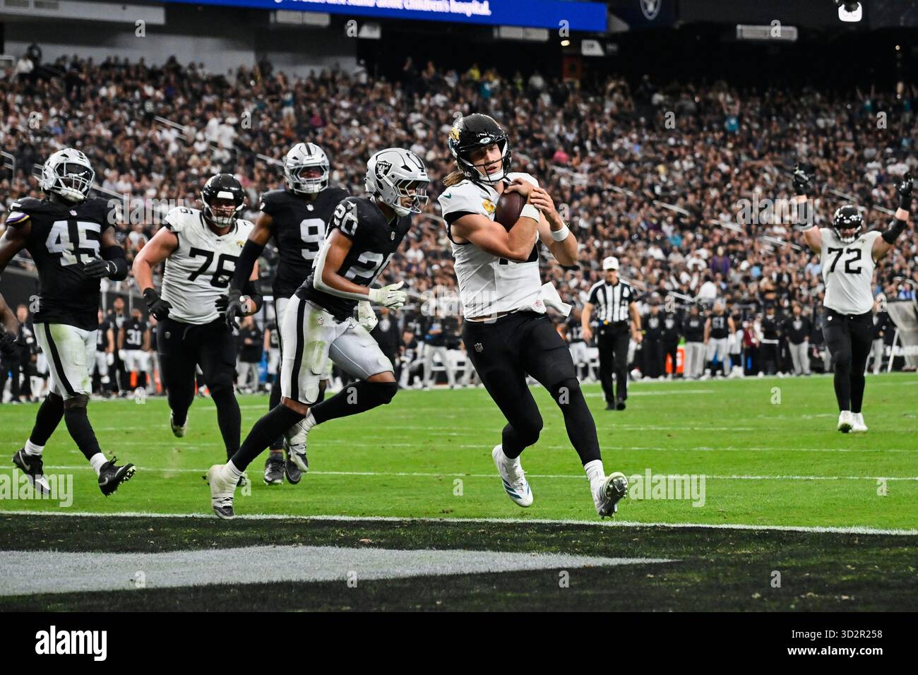 Jacksonville Jaguars quarterback Trevor Lawrence (16) scores a touchdown next to Las Vegas ...