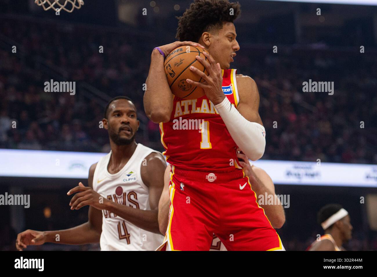 Atlanta Hawks' Jalen Johnson (1) grabs a rebound in front of Cleveland Cavaliers' Evan Mobley (4 ...