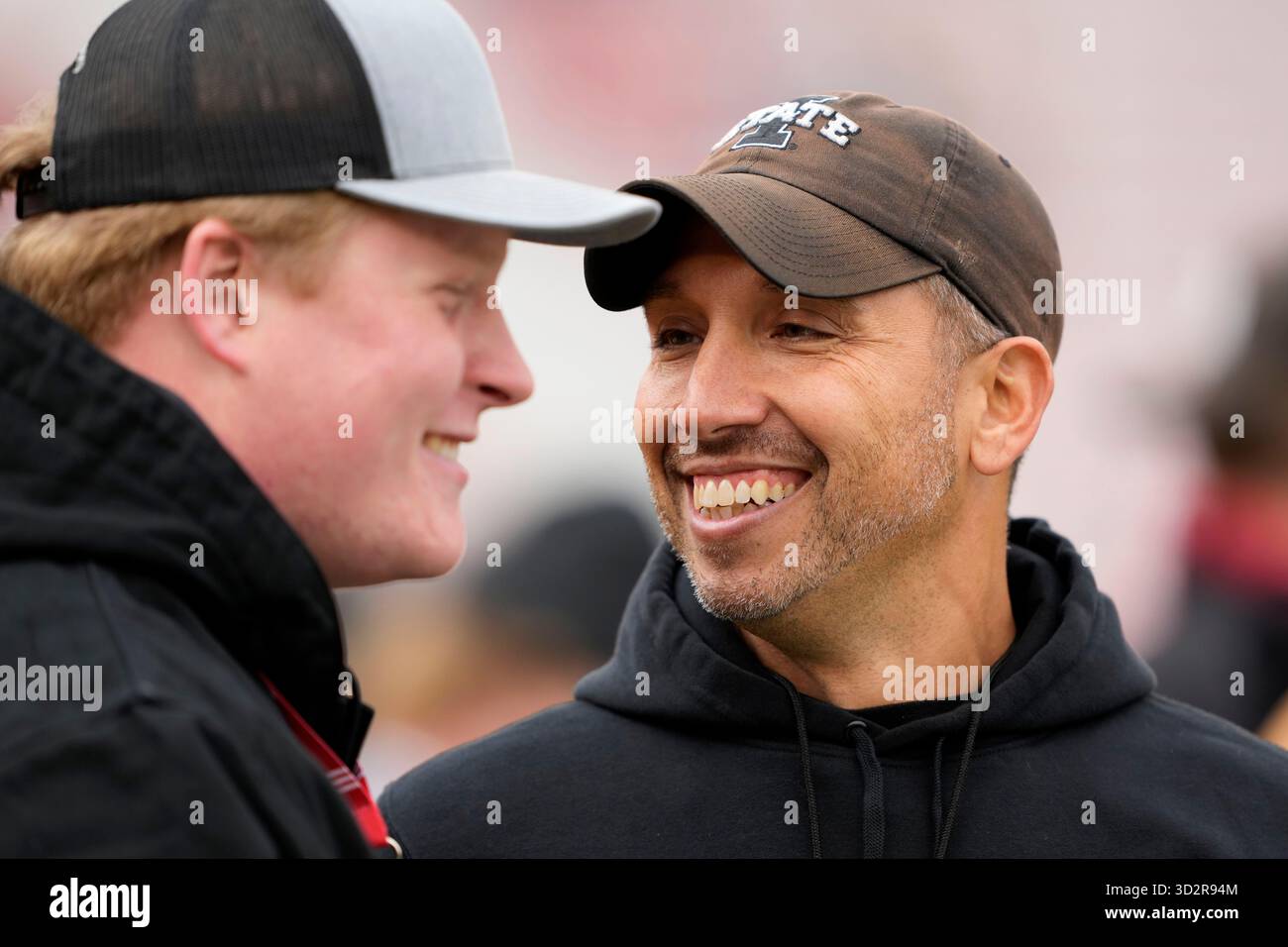 Iowa State head coach Matt Campbell, right, stands on the field before ...